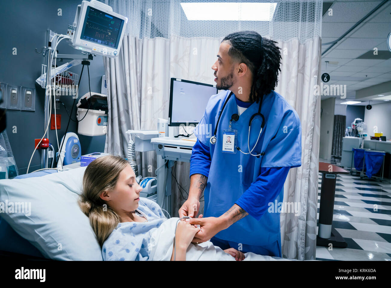 Nurse placing finger monitor on patient Stock Photo - Alamy