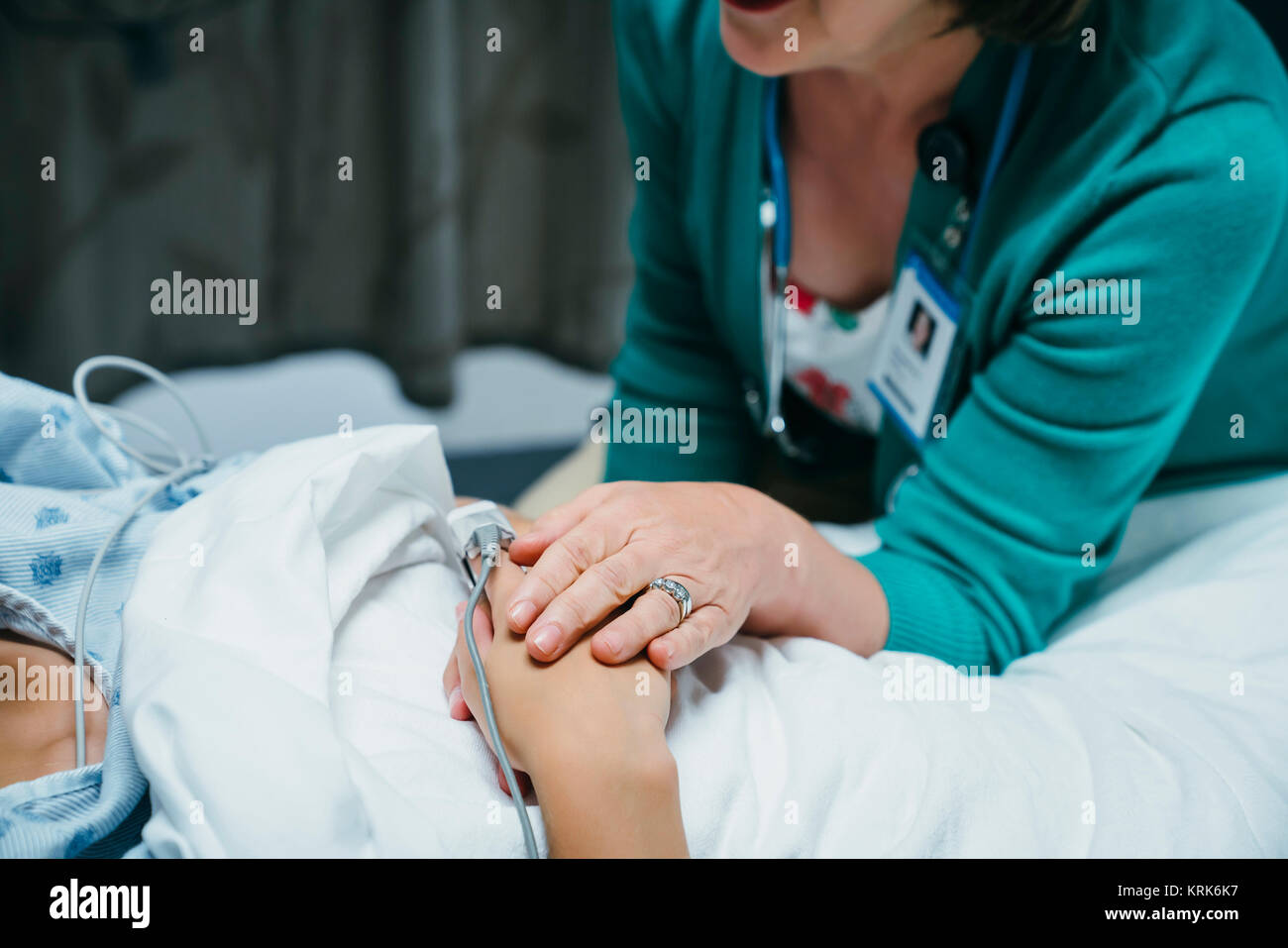 Caucasian doctor comforting patient in hospital bed Stock Photo - Alamy