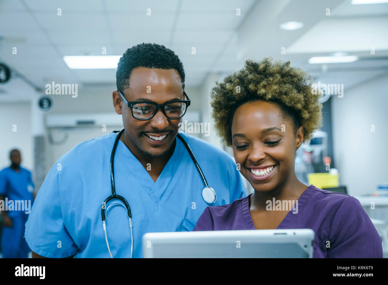 Smiling black nurses using digital tablet Stock Photo - Alamy