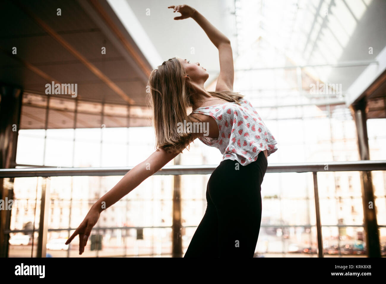 Caucasian woman dancing near railing Stock Photo - Alamy