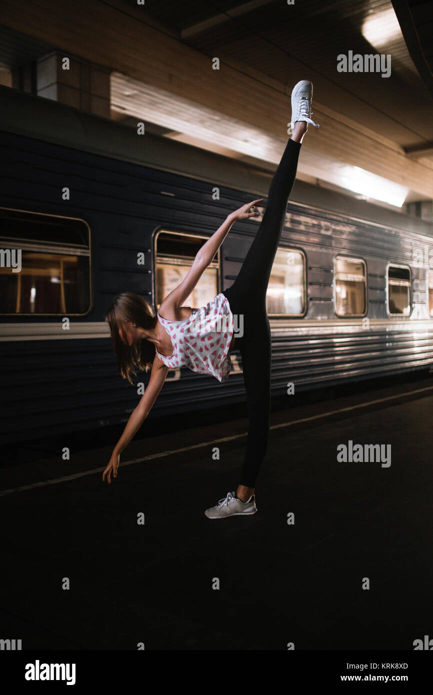 Caucasian woman dancing near train Stock Photo - Alamy