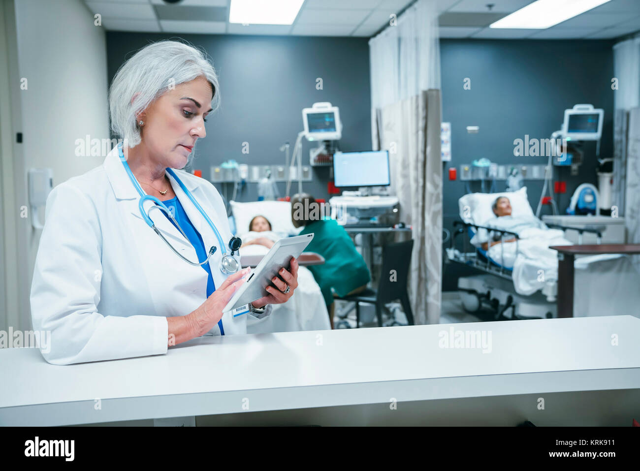 Doctor using digital tablet in hospital Stock Photo - Alamy
