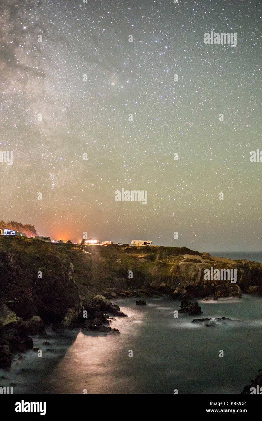 Night sky over cliff at ocean Stock Photo - Alamy