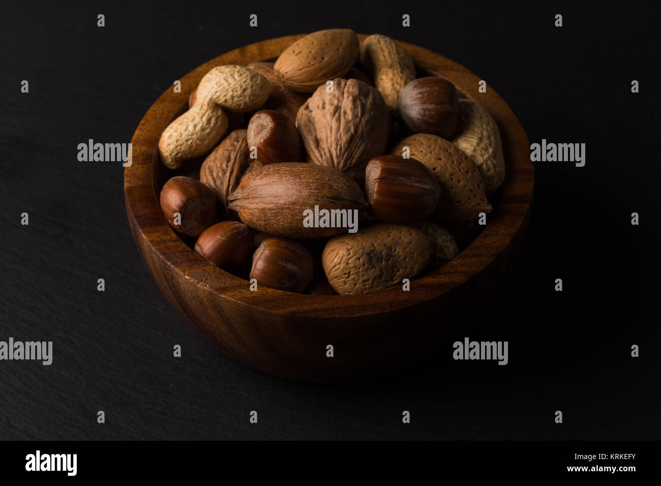 Mixed nuts in shells in a bowl Stock Photo - Alamy
