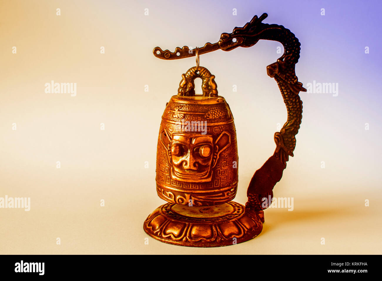Chinese temple bell small, gray purple background Stock Photo - Alamy