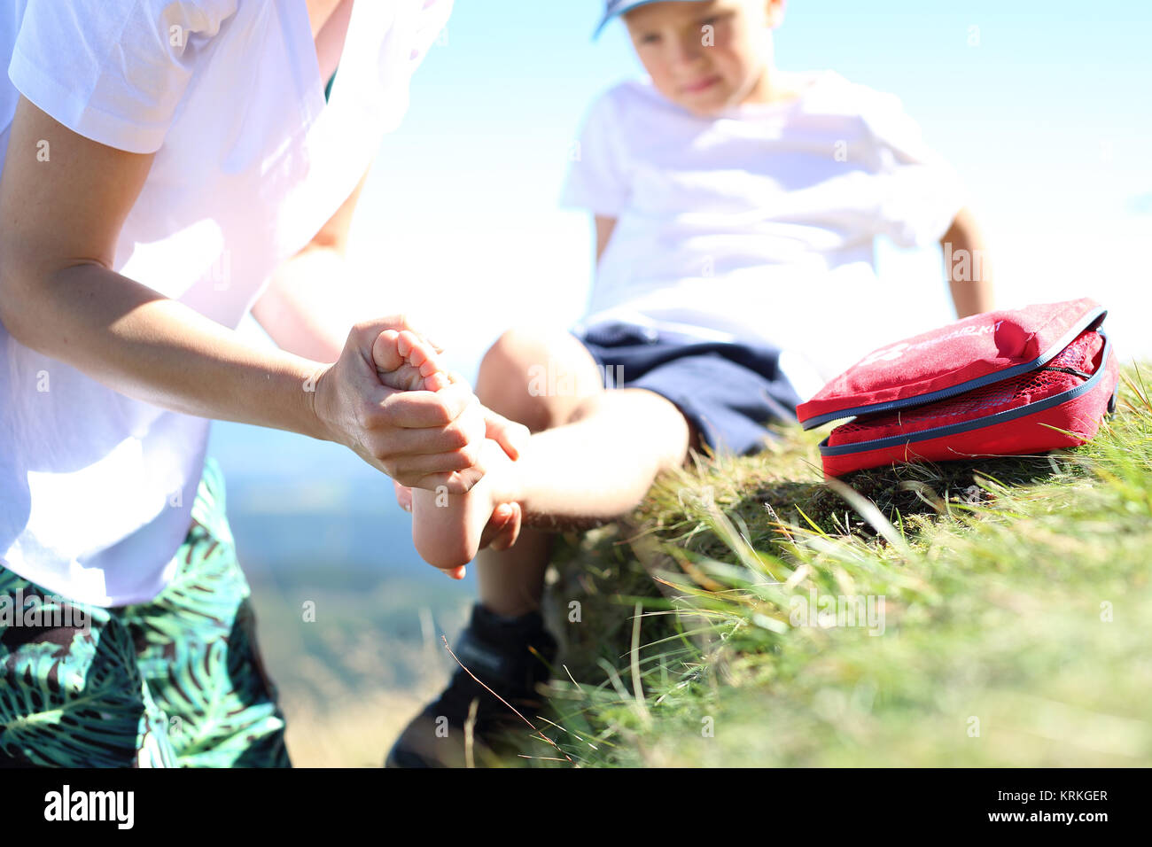 bandaging foot injury,child twisted leg Stock Photo - Alamy