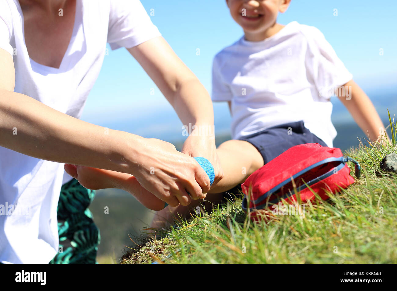 bandaging foot injury,child twisted leg Stock Photo - Alamy