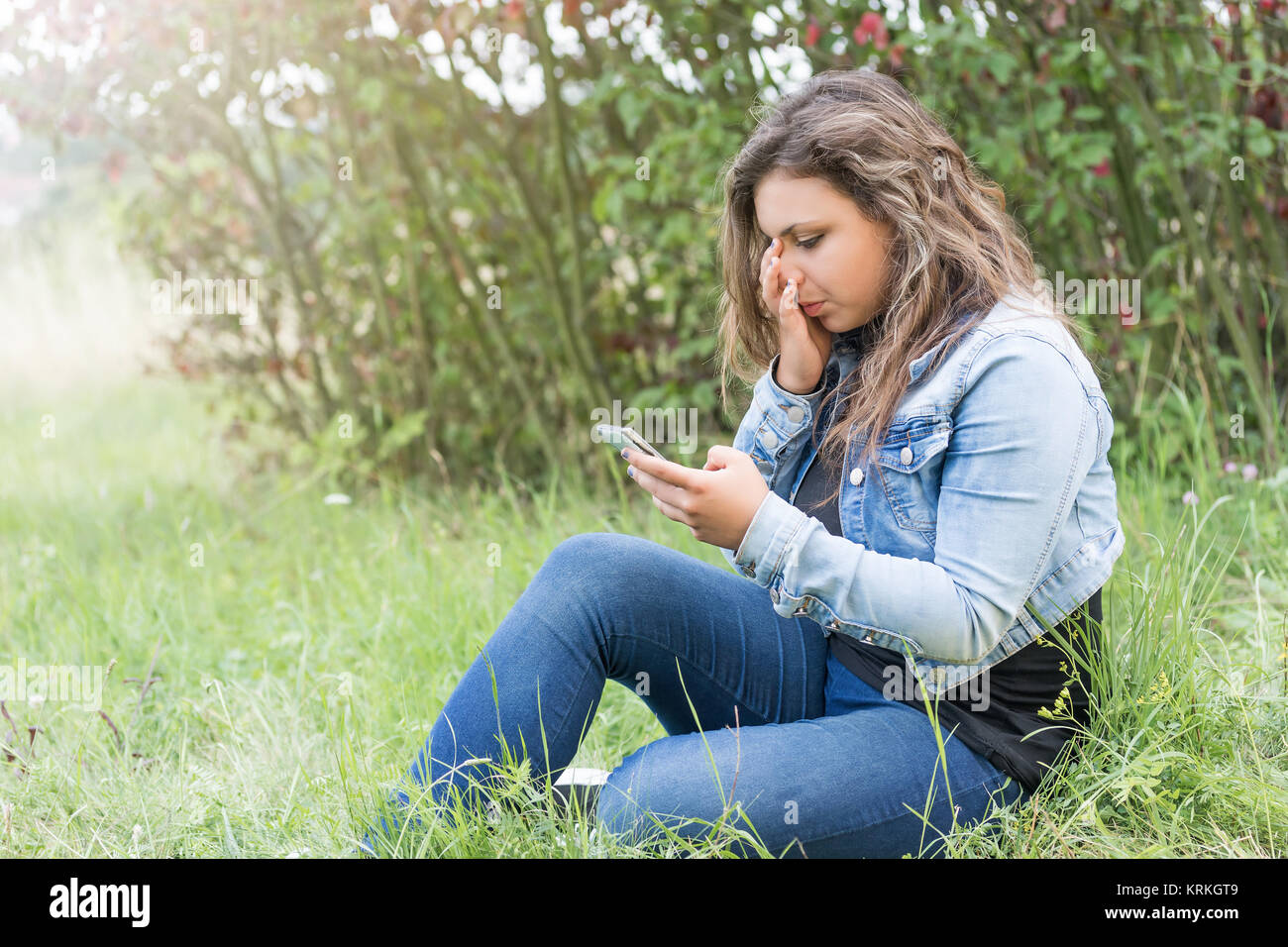 The girl is crying looking at her smart phone Stock Photo - Alamy