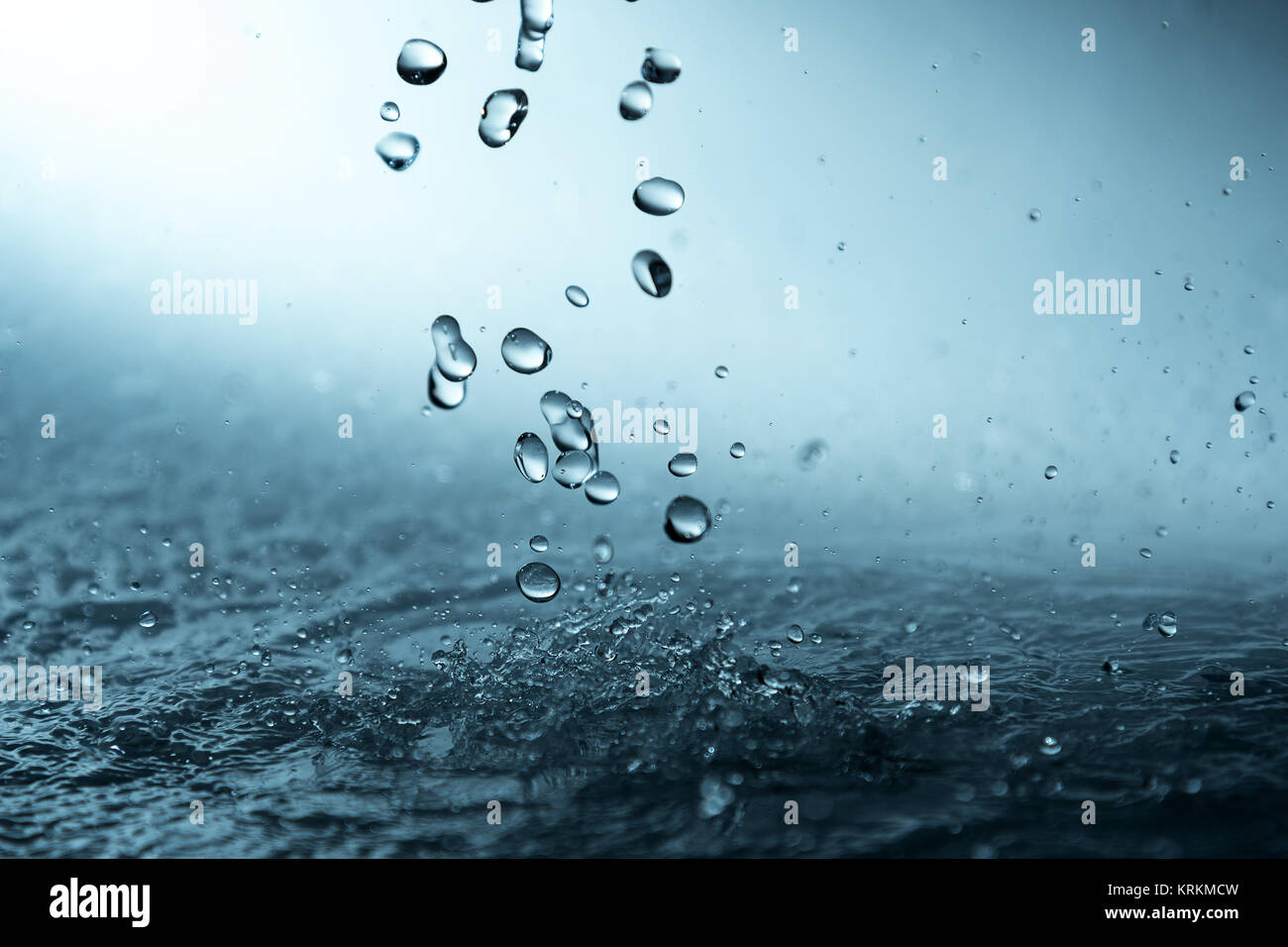 Falling and splashing water drops Stock Photo - Alamy