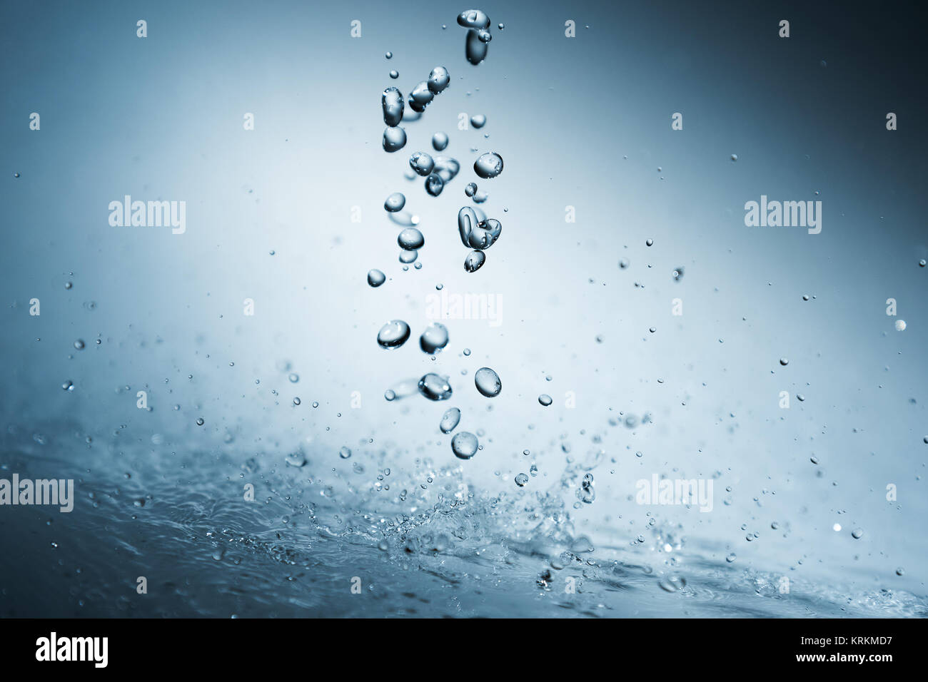 Falling and splashing water drops Stock Photo - Alamy