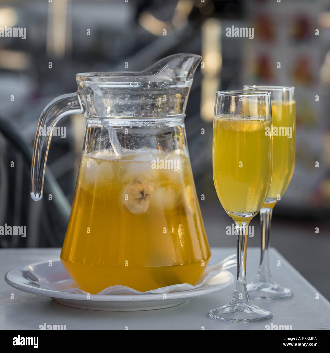Yellow champagne sangria served in a mug with two glasses Stock Photo ...