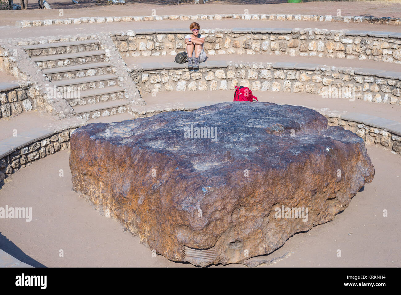 Tourist looking at Hoba meteorite, Namibia, Africa. The meteorite is ...