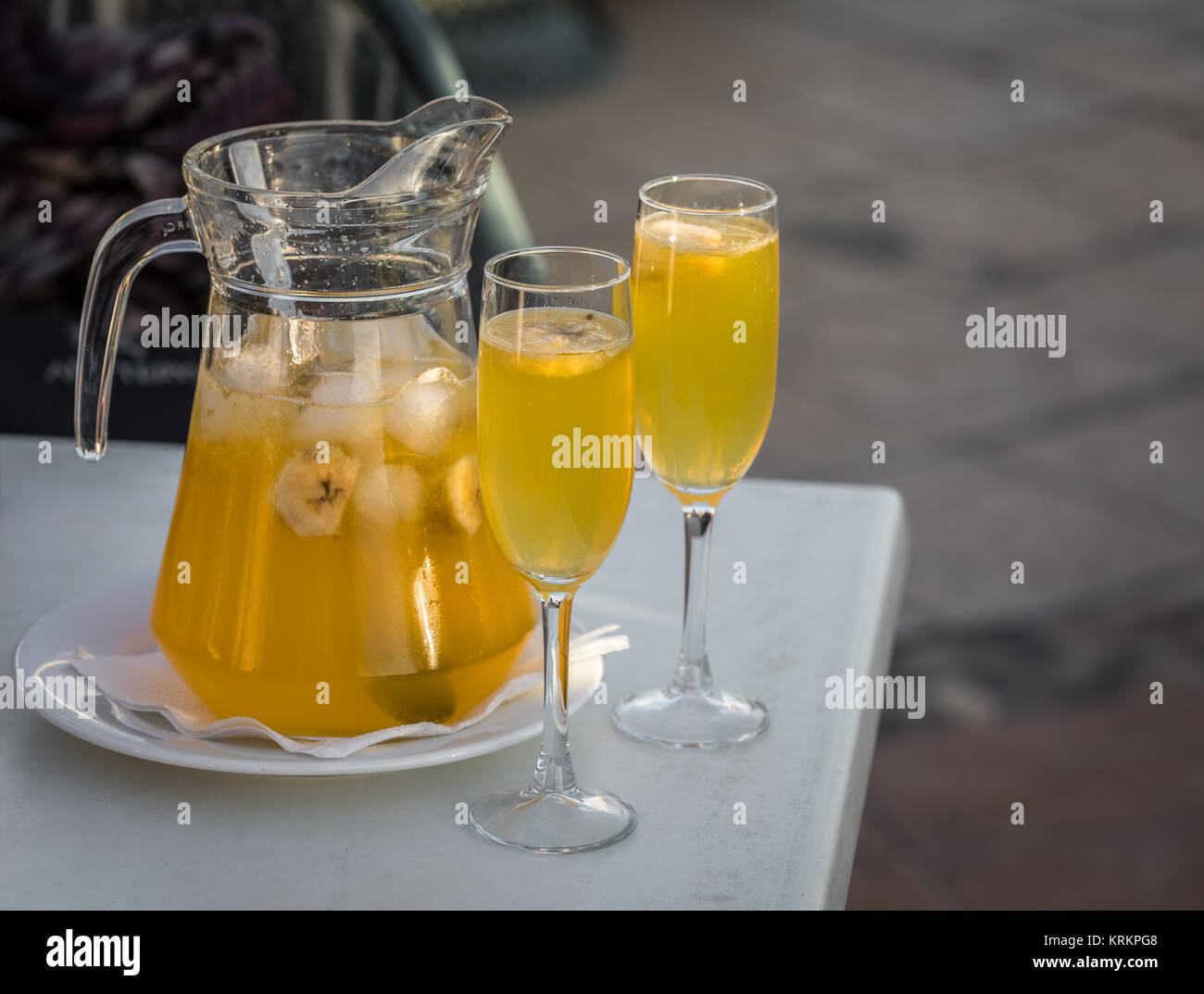 Yellow champagne sangria served in a mug with two glasses Stock Photo ...