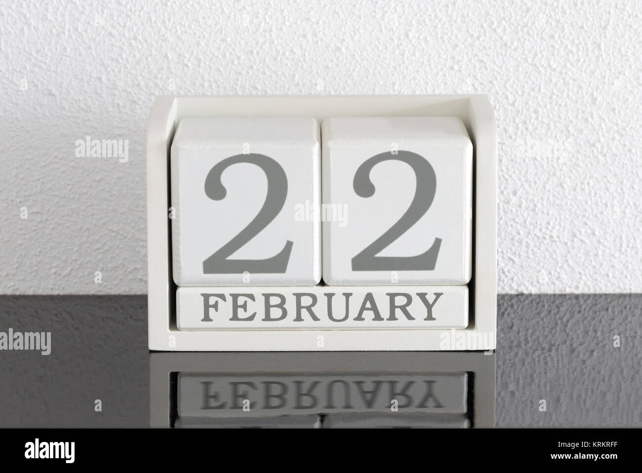 White block calendar present date 22 and month February on white wall ...