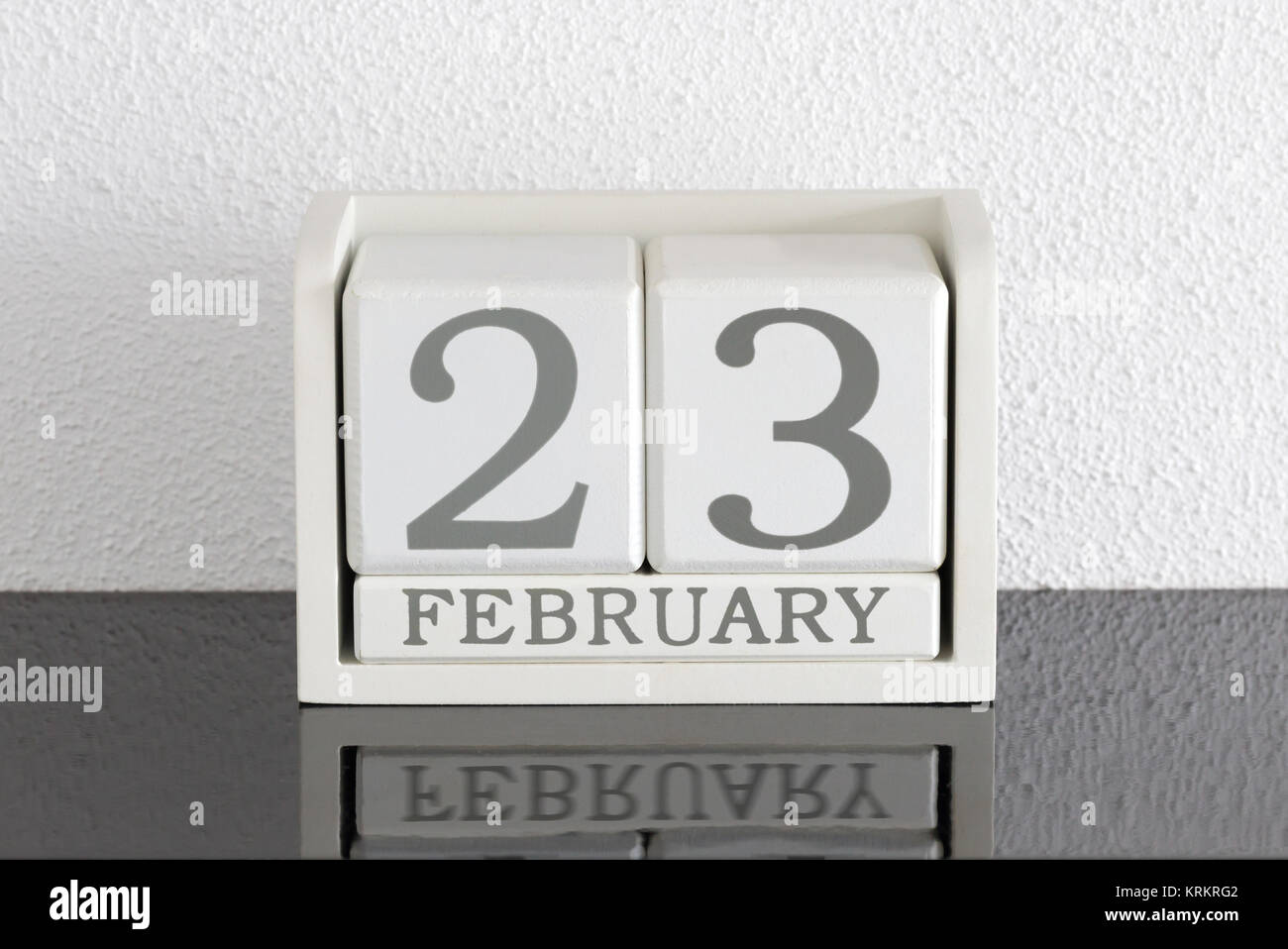 White block calendar present date 23 and month February on white wall ...