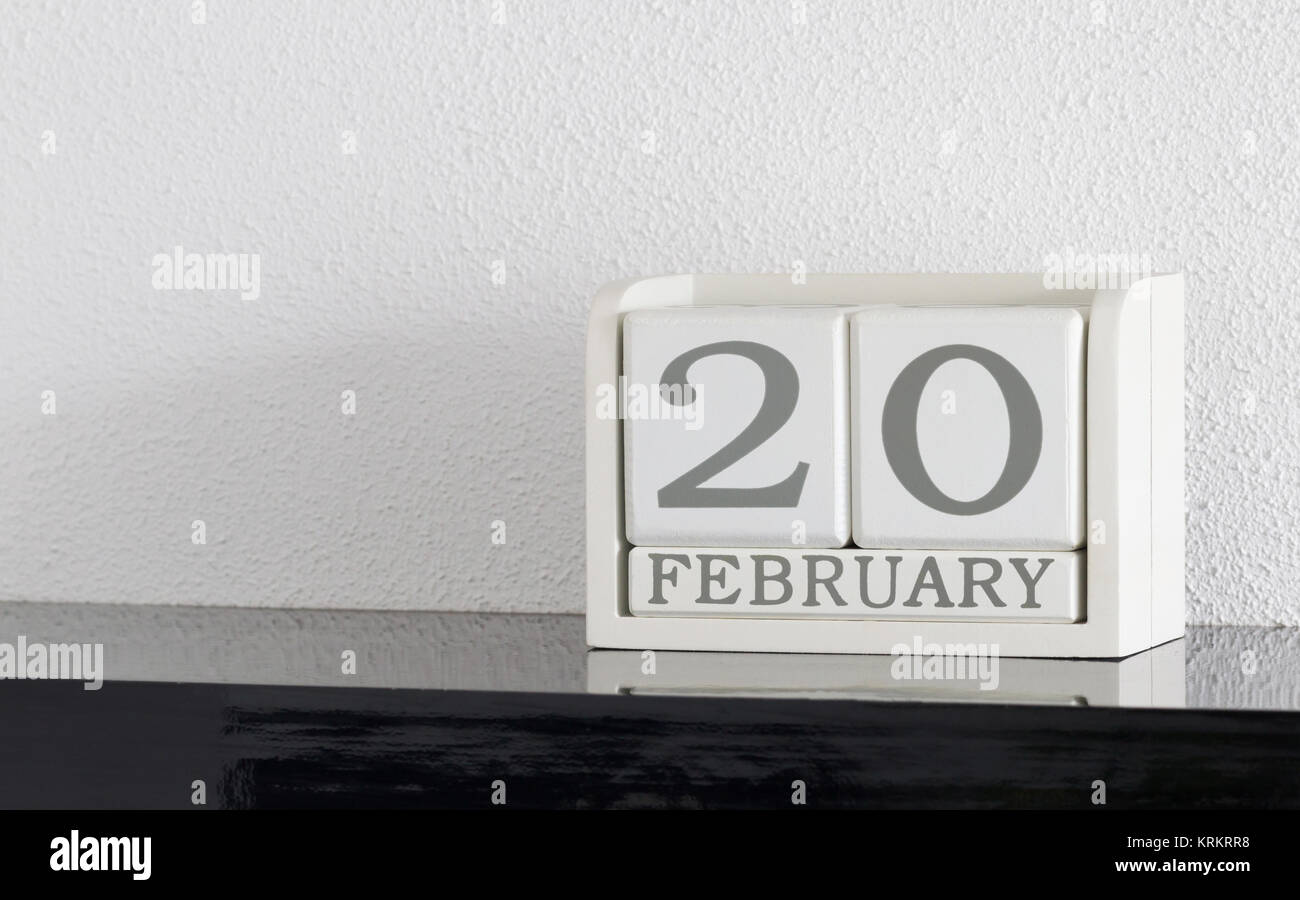 White block calendar present date 20 and month February on white wall ...