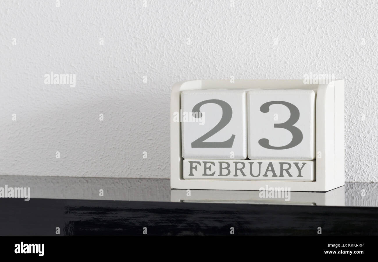 White block calendar present date 23 and month February on white wall ...