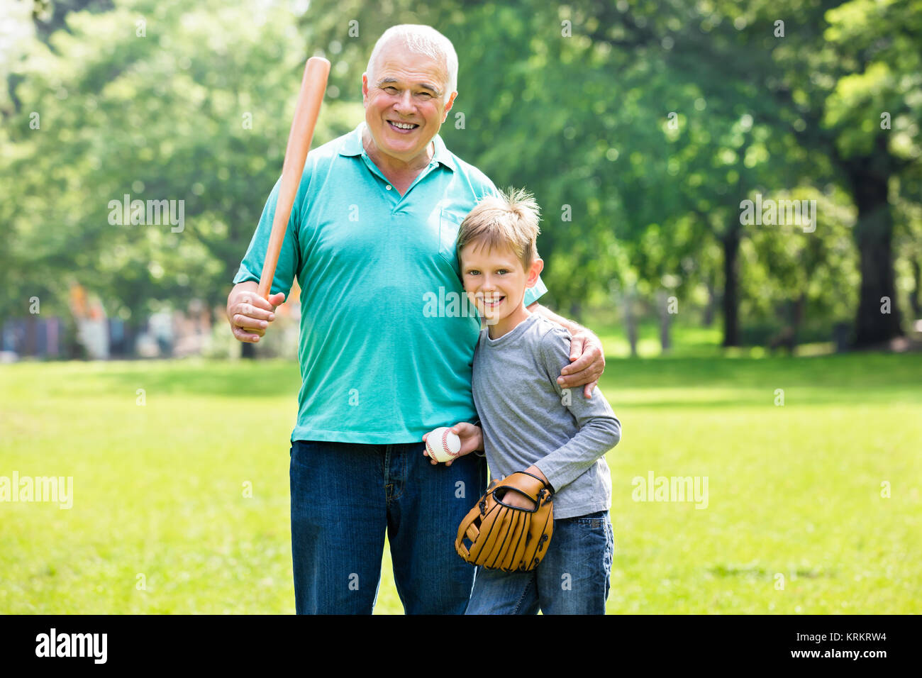 Grandson And Grandfather Playing Baseball Stock Photo - Alamy