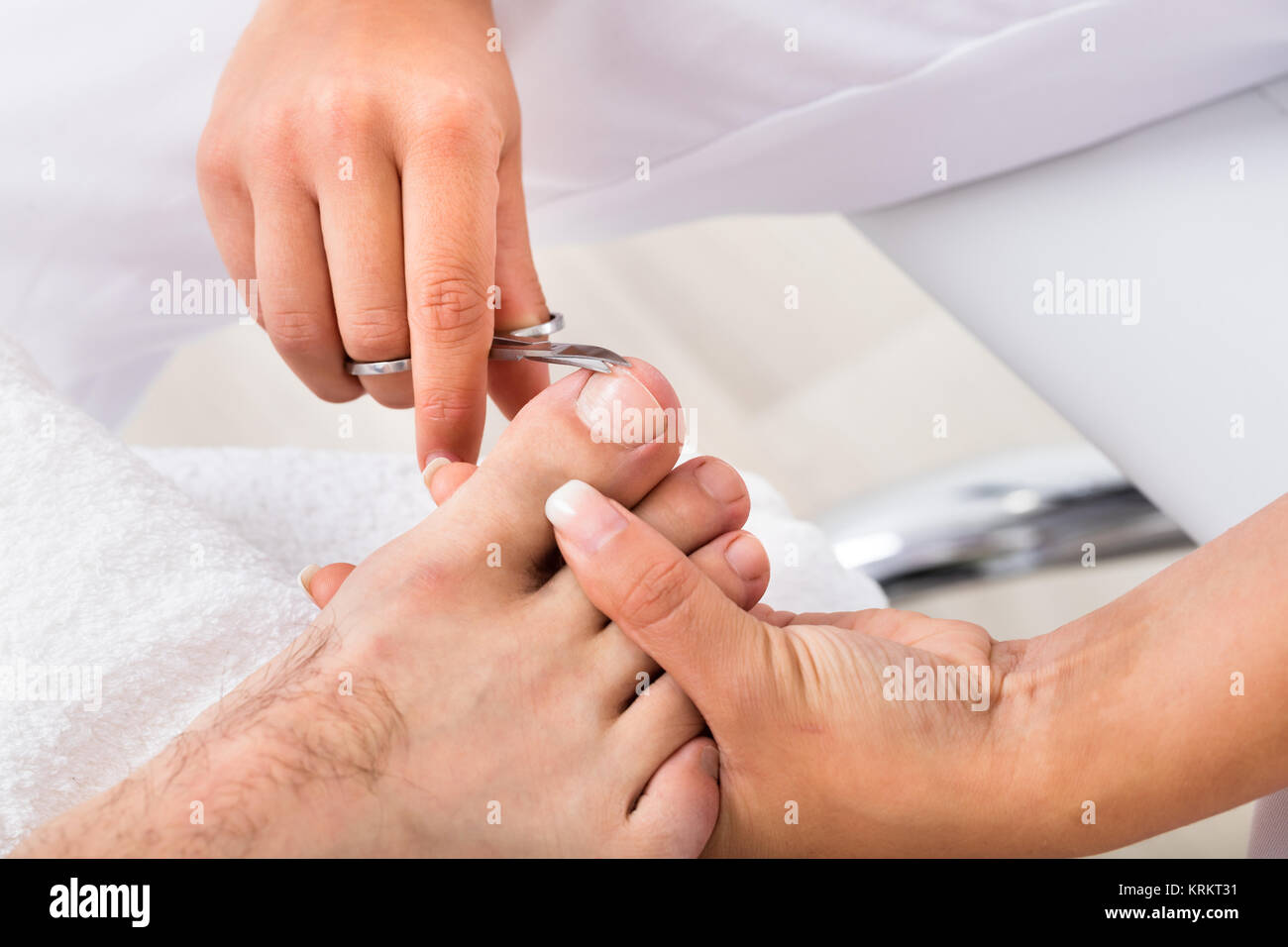 Manicurist With Scissors Trimming Person's Toenail Stock Photo - Alamy