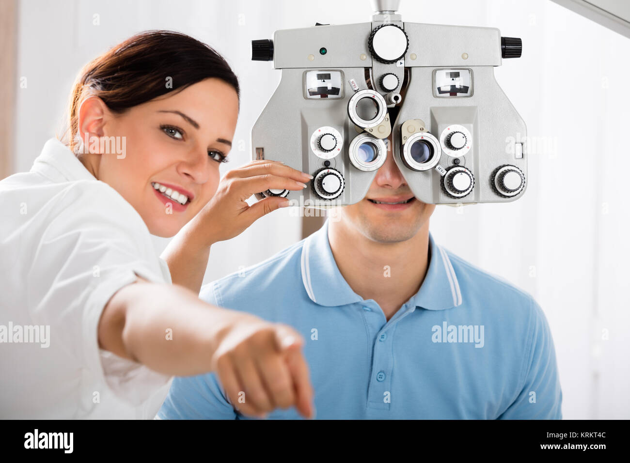 Female Optometrist Doing Sight Testing For Patient Stock Photo - Alamy