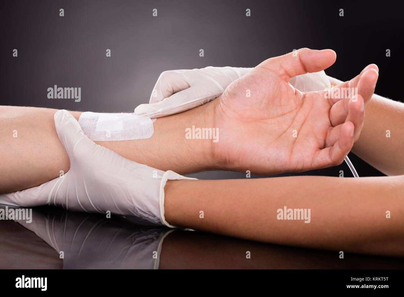 Doctor Holding Patient's Hand With Iv Drip Stock Photo - Alamy