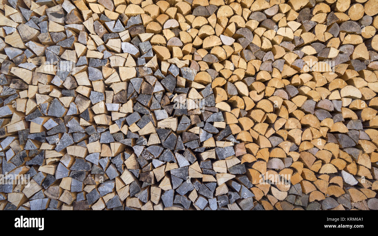 pile of firewood with a pattern of brown and gray logs Stock Photo - Alamy
