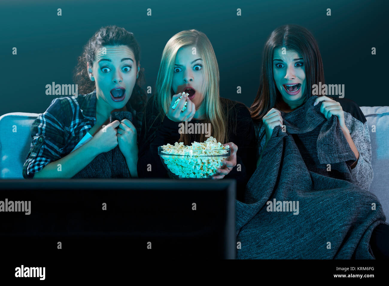 Scared teenage watching movies Stock Photo - Alamy