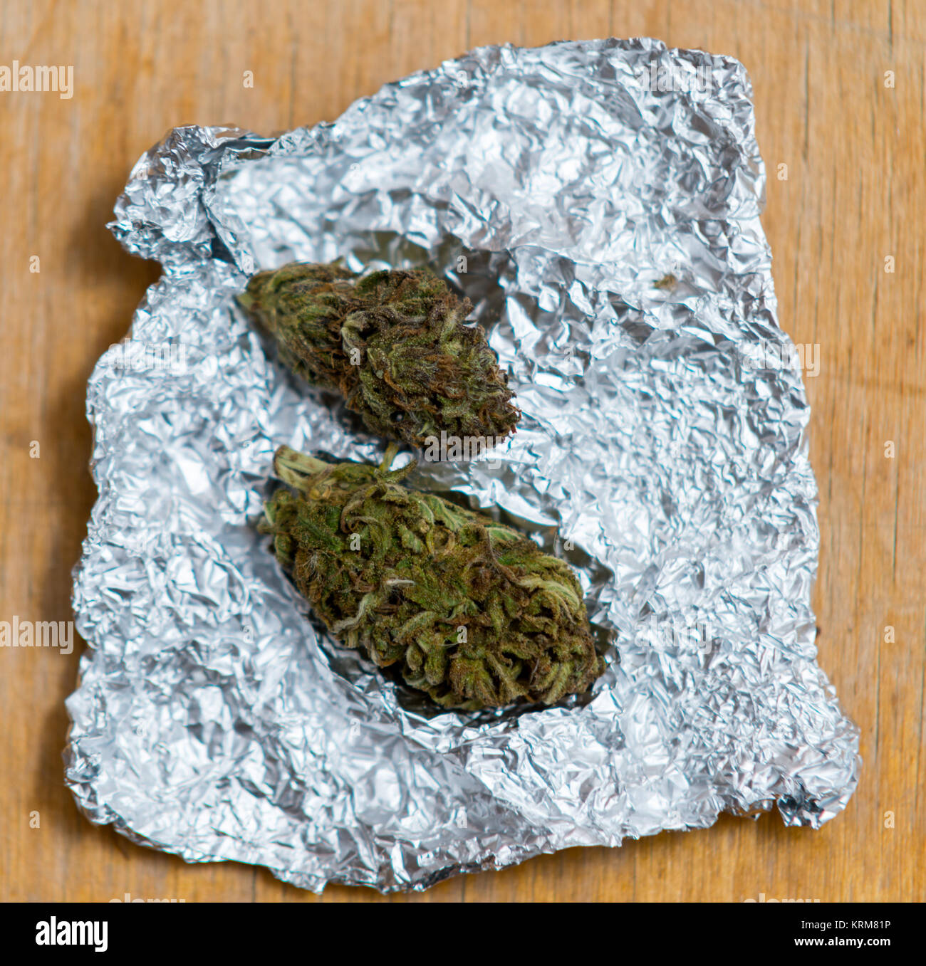close up on Marijuana in tin foil on table Stock Photo - Alamy