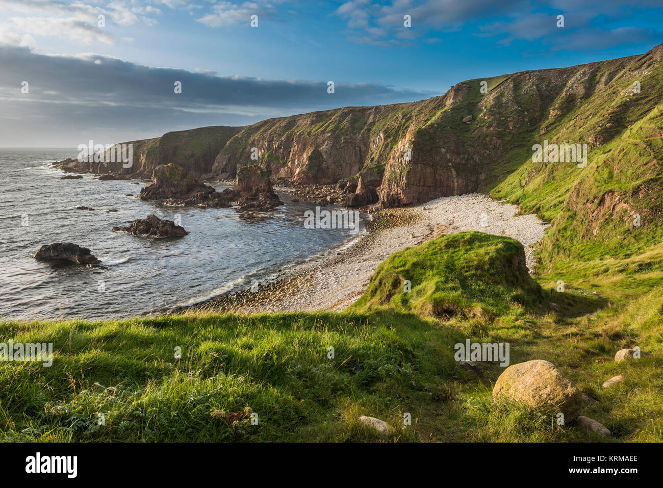 Cliffs, sea stacks, shingle beach and cove at Bloody Foreland, at the ...