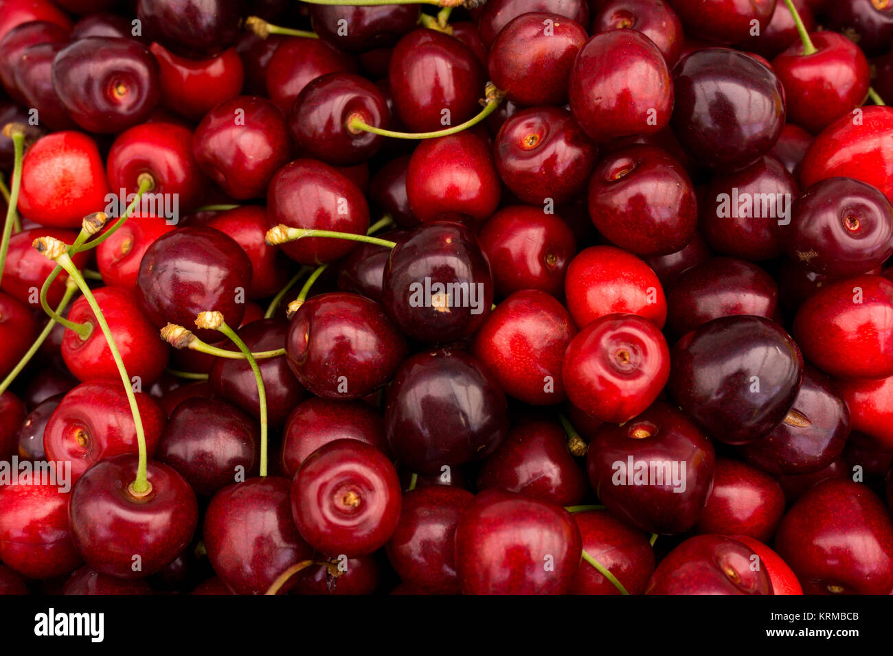 red cherry background. Red ripe delicious cherries Stock Photo - Alamy