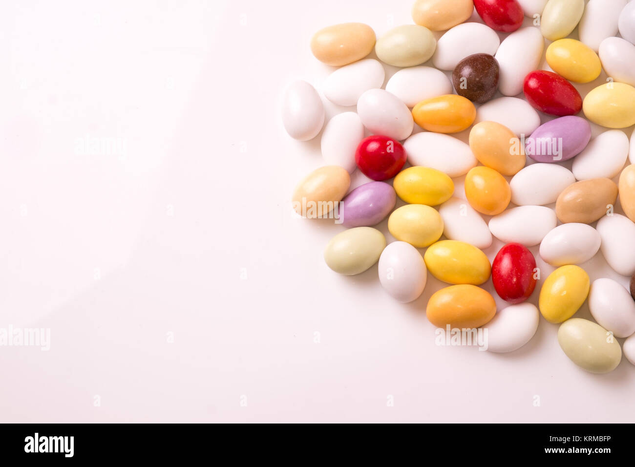 Colored sugared almonds arranged on a white background Stock Photo - Alamy