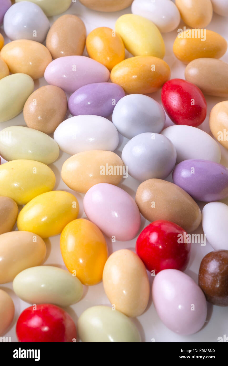 Colored sugared almonds arranged on a white background Stock Photo - Alamy