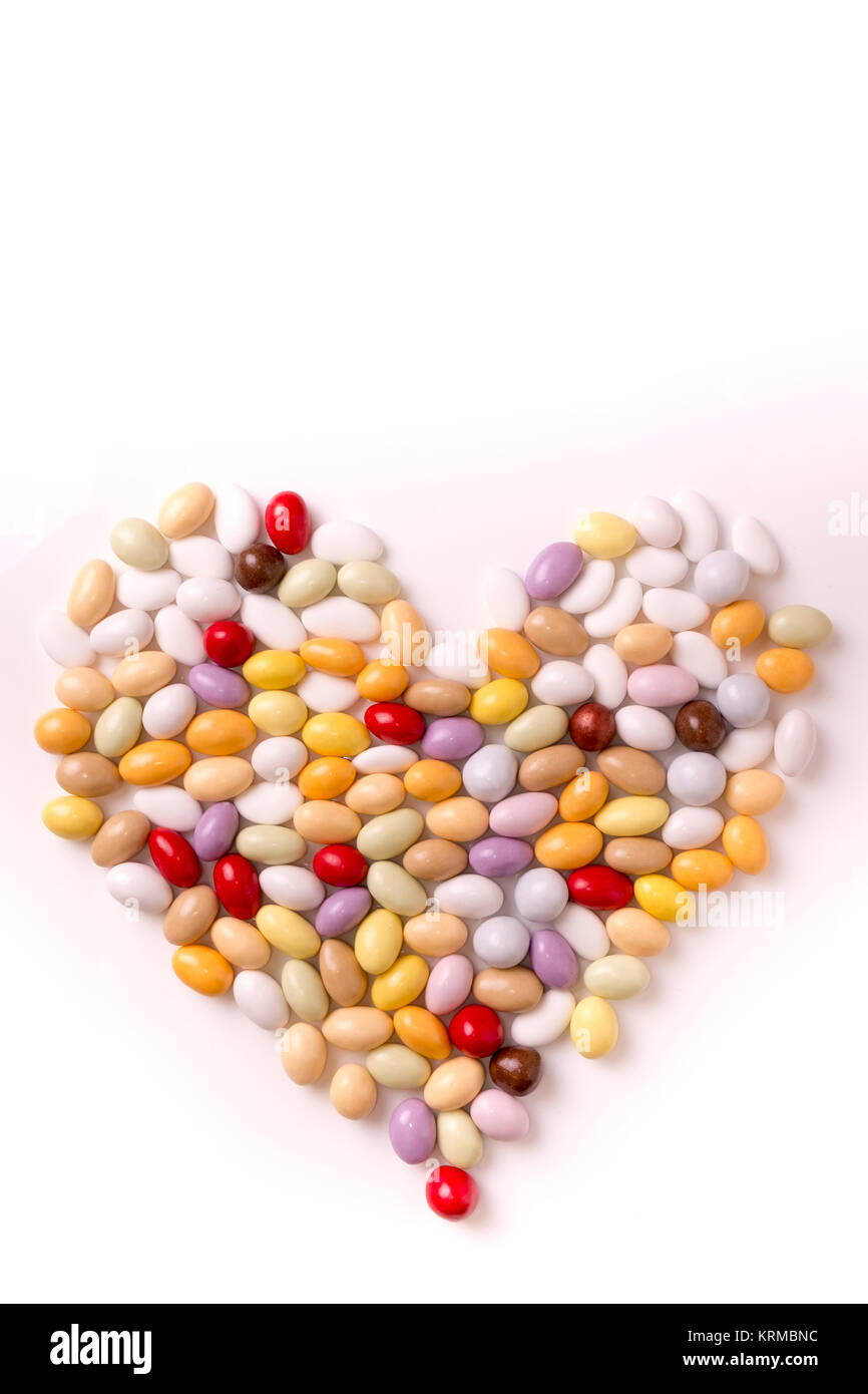 Colored sugared almonds arranged on a white background Stock Photo - Alamy