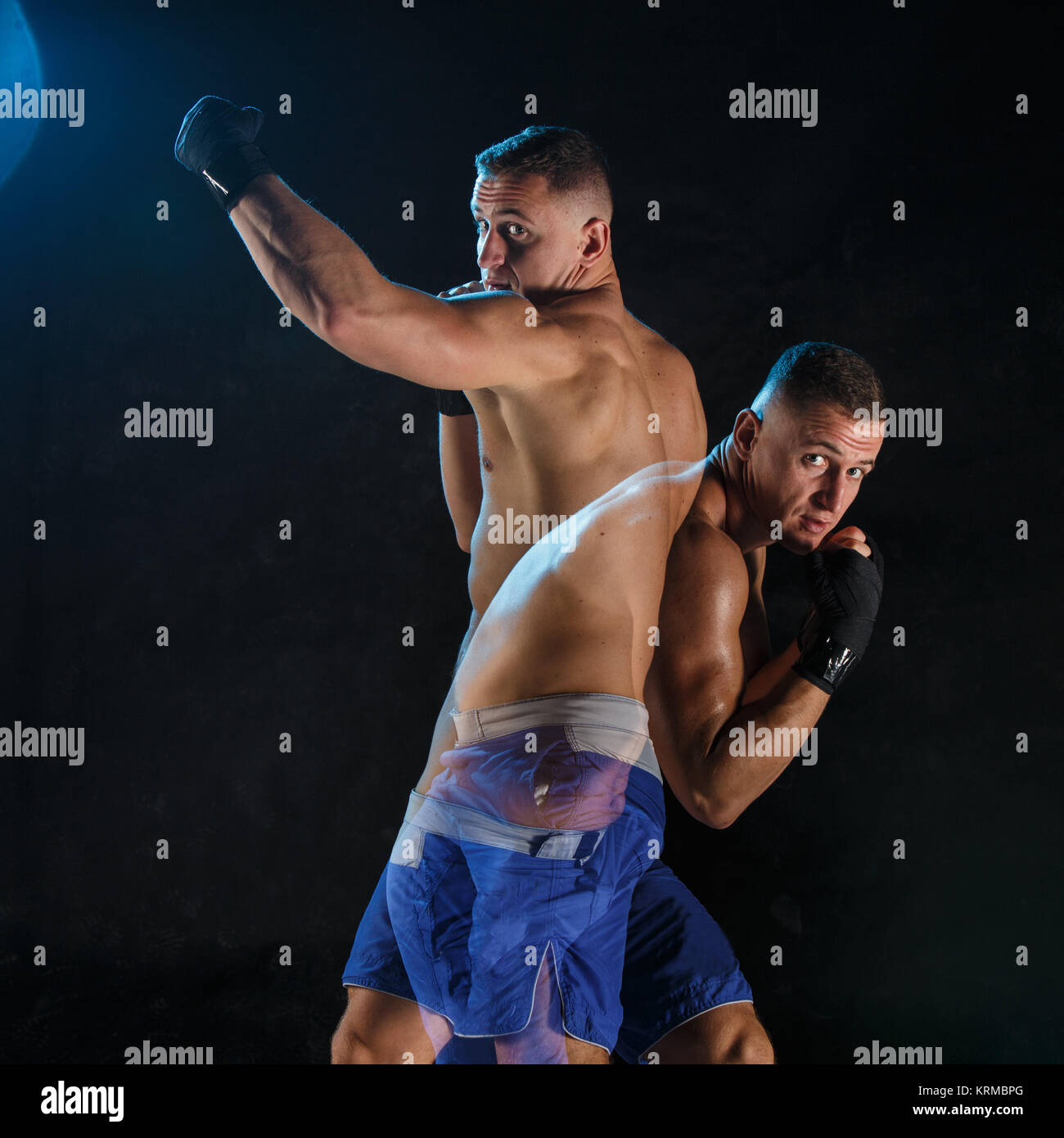 Male boxer boxing in a dark studio Stock Photo - Alamy