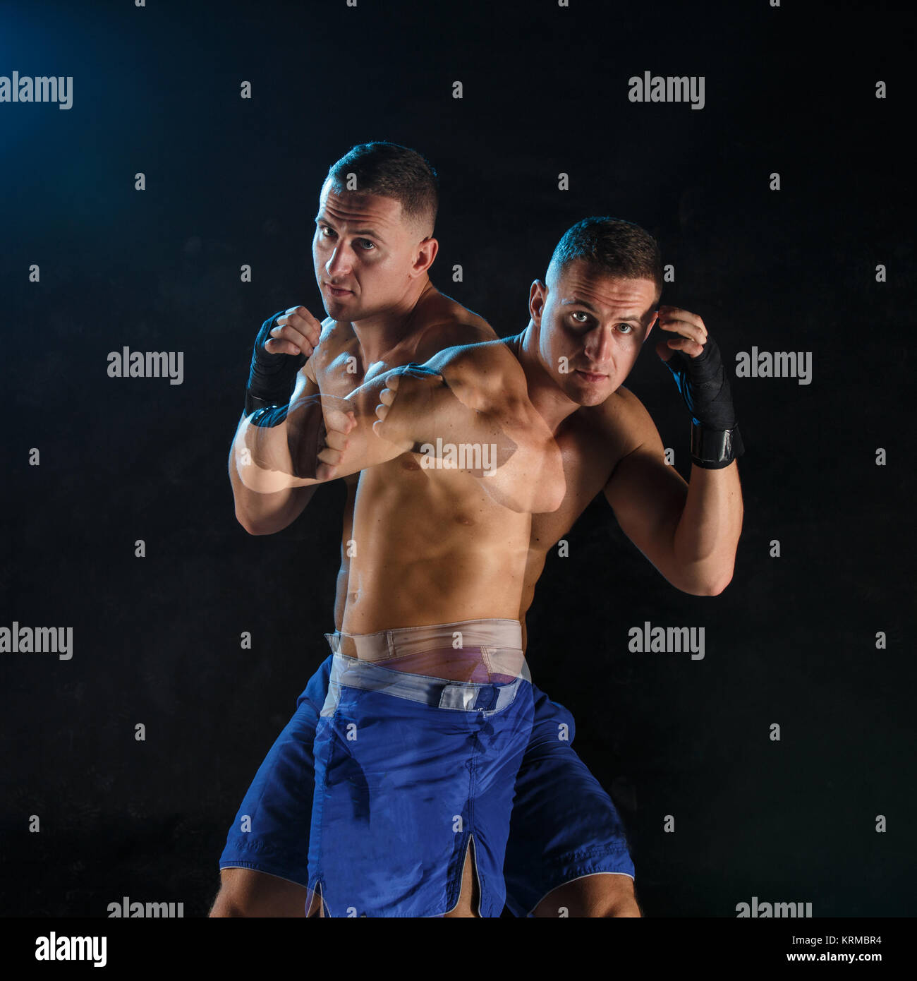 Male boxer boxing in a dark studio Stock Photo - Alamy