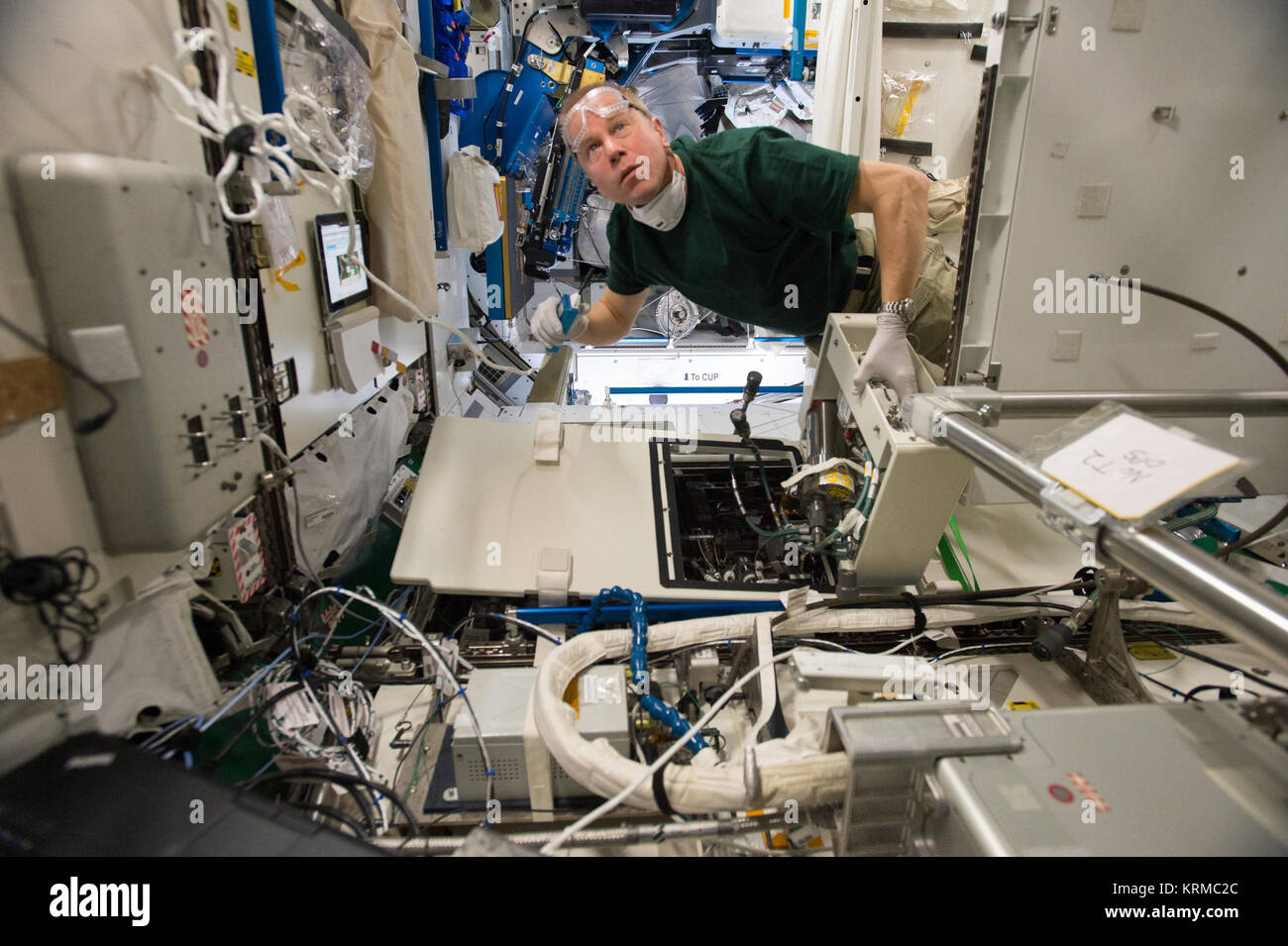 ISS-46 Tim Kopra performs regular maintenance on the Urine Processing ...