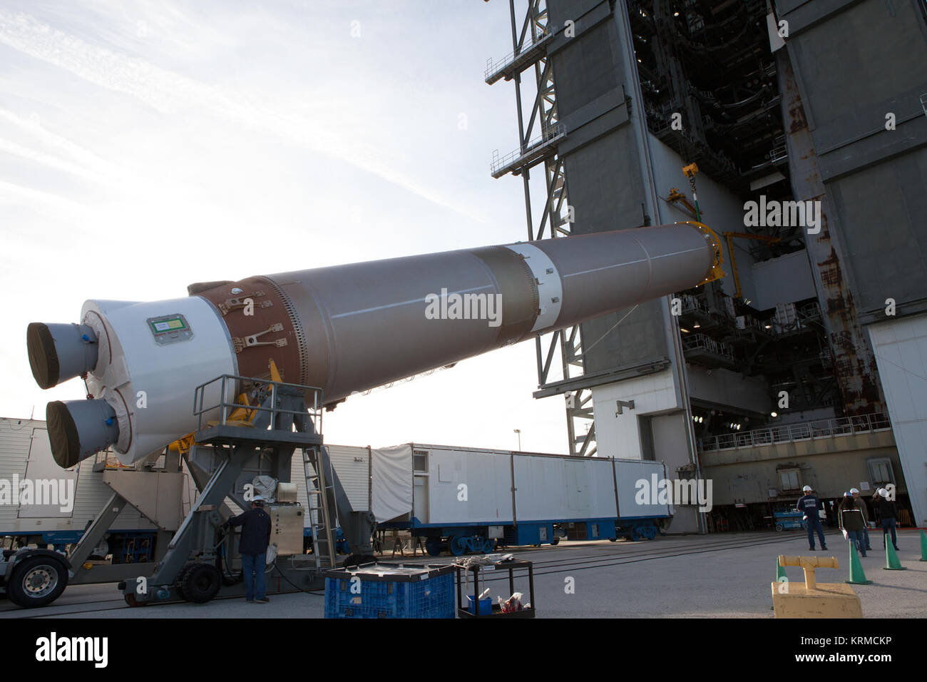 The First Stage Booster for Cygnus Orbital OA-6 being lifted to ...