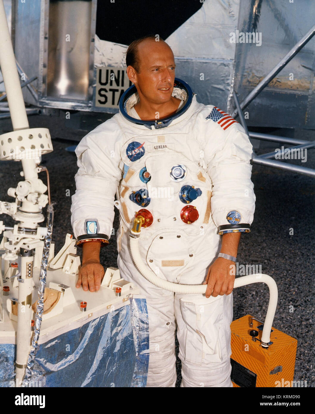 Pete Conrad poses with his right hand on a Central Station mock-up ...