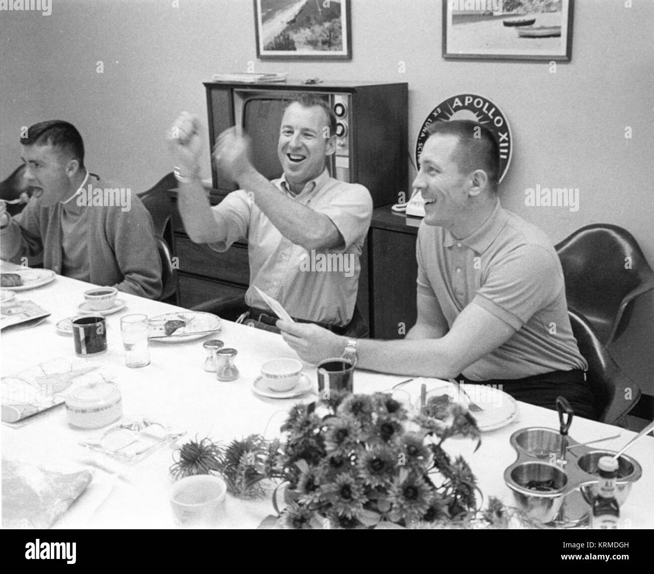 Fred Haise (left), Jim Lovell, and Jack Swigert, at breakfast on launch ...