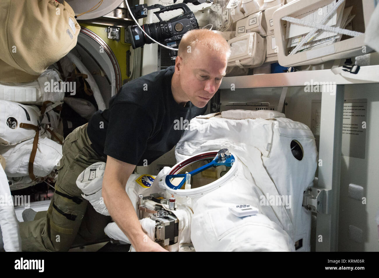 ISS-47 Tim Kopra with space suits in the Quest airlock Stock Photo - Alamy