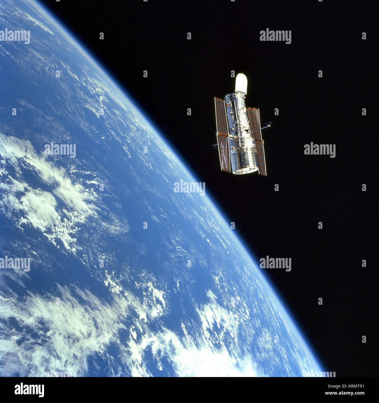 The Hubble Space Telescope (HST) floats gracefully above the blue Earth ...