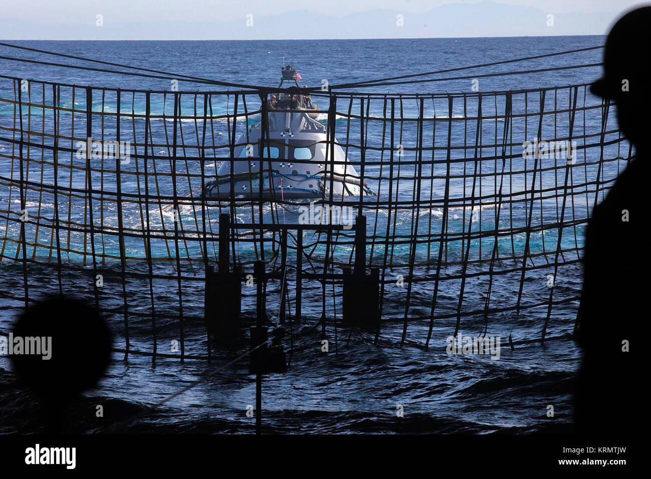 A test version of the Orion crew module floats outside the well deck of ...