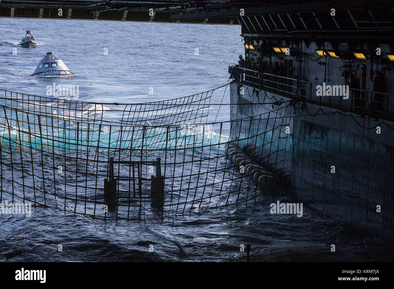 A test version of the Orion crew module floats outside the well deck of ...