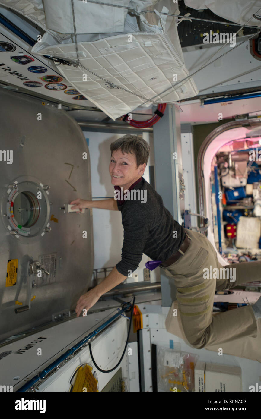ISS-50 Peggy Whitson works inside the Harmony module to open HTV-6 ...