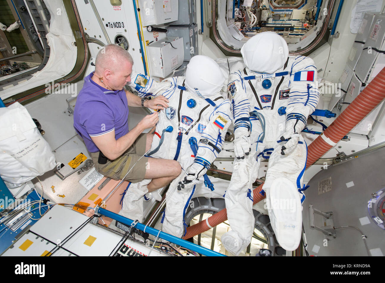 ISS-51 Oleg Novitskiy works on Sokol suits inside the Unity module ...