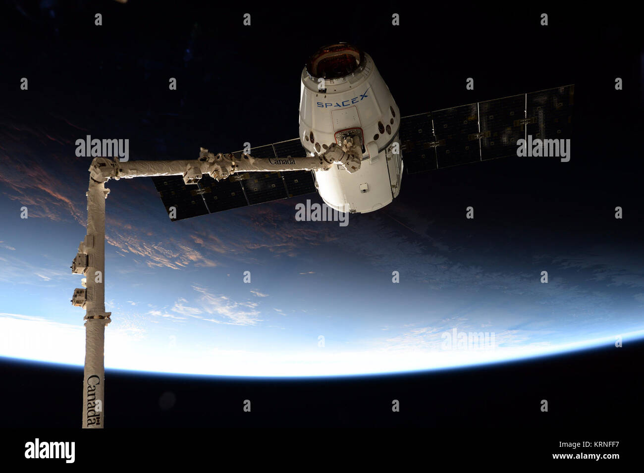 SpaceX CRS-12 Dragon grappled by the ISS Canadarm2 Stock Photo - Alamy