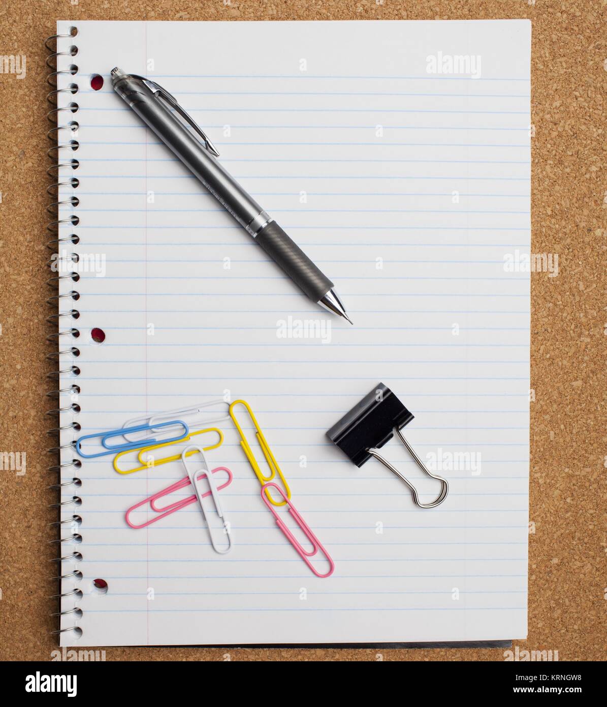 pen and paperclips on notebook Stock Photo - Alamy