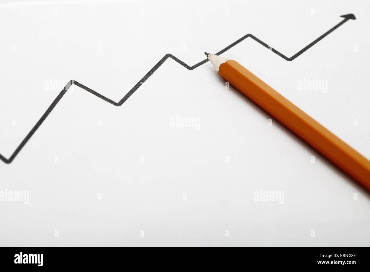 pencil on financial graph Stock Photo - Alamy