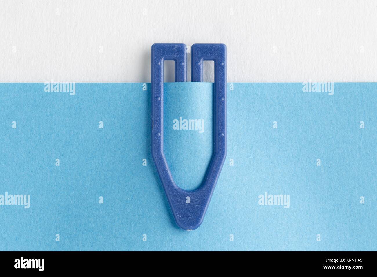 plastic paper clip on blue note Stock Photo - Alamy