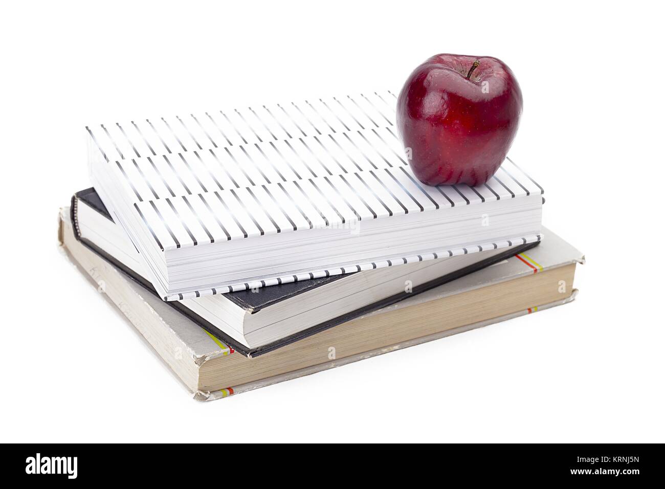 stack of books with an apple on top Stock Photo - Alamy